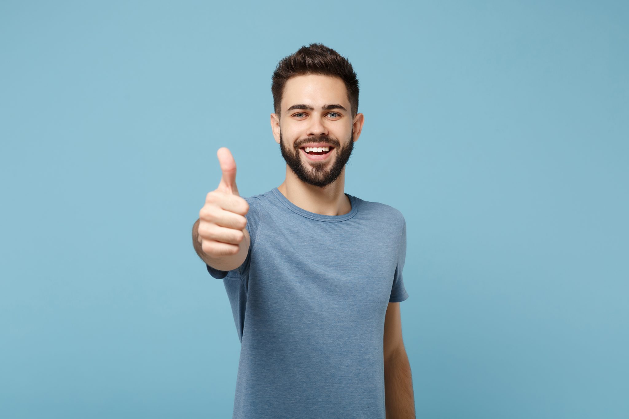 Young smiling cheerful handsome man in casual clothes posing isolated ...