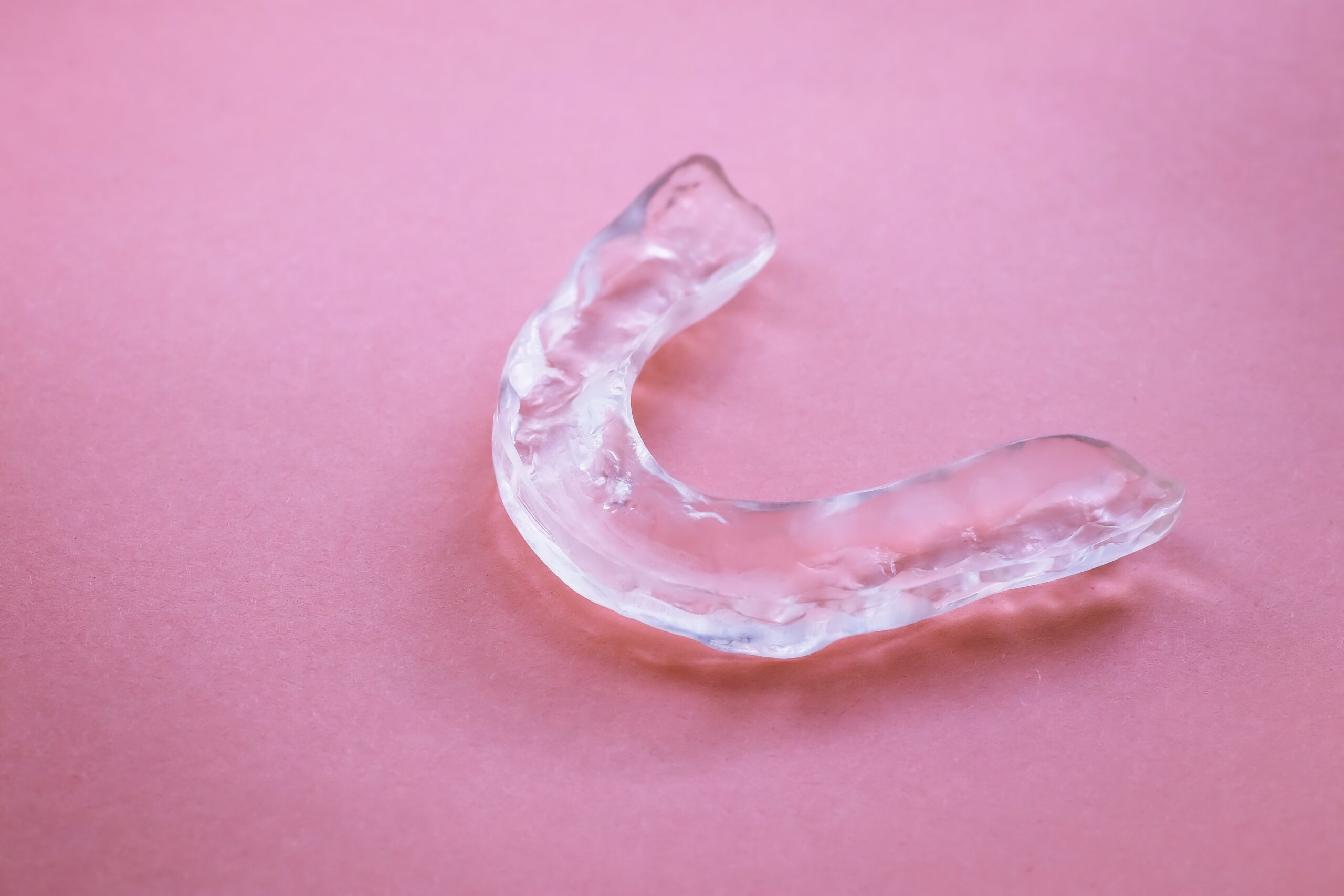 Dental splint on pink background for supporting structures and teeth ...